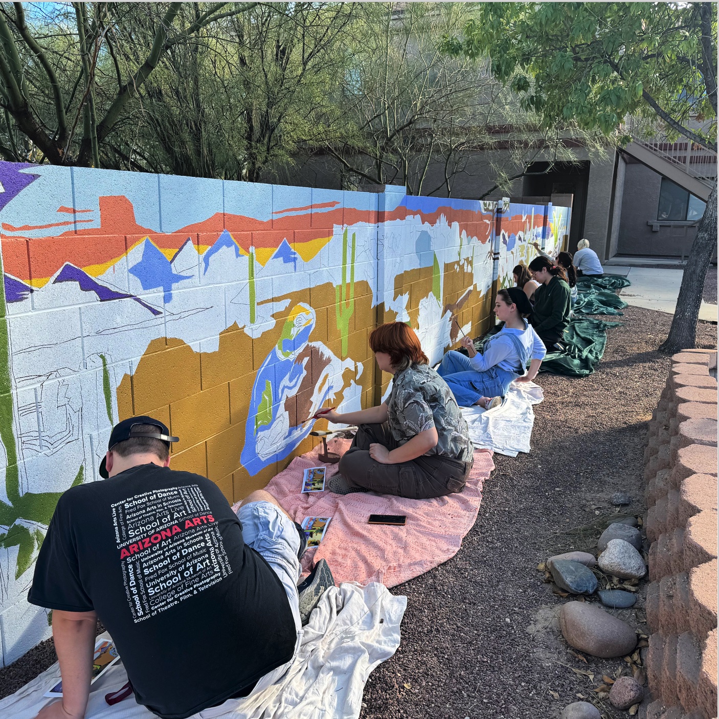 Students paint 80-foot-long mural at housing complex for older adults ...